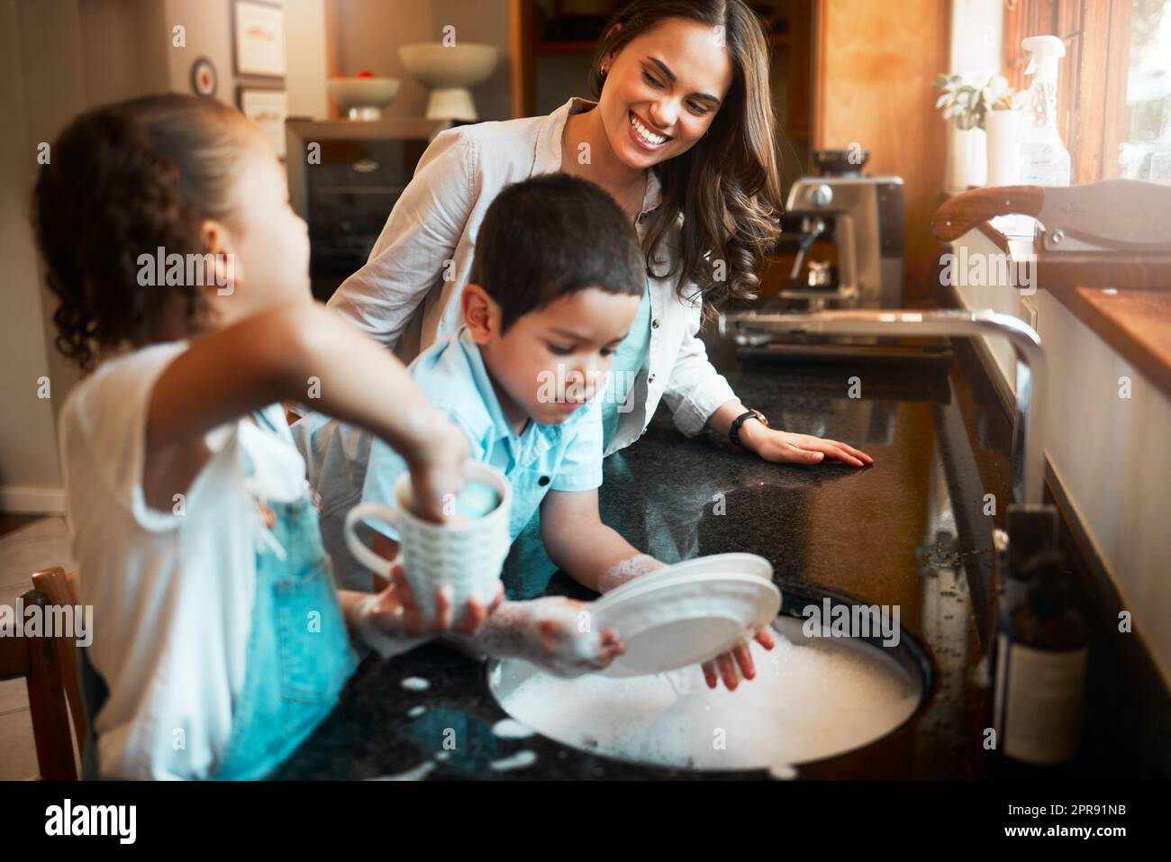 Daughter and son helping mom clean hi-res stock photography and images ...