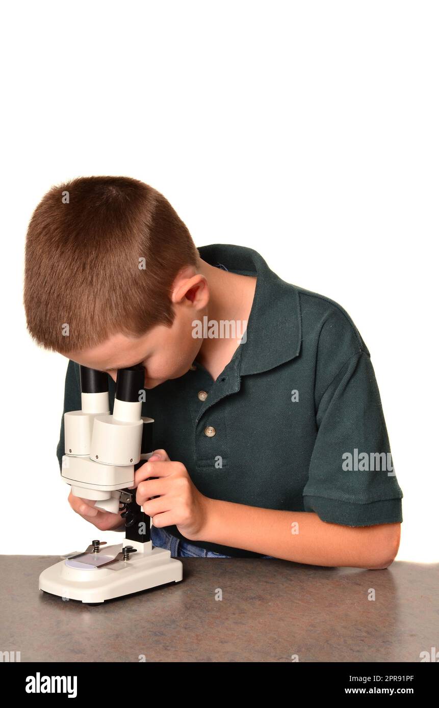 Young boy looking through a microscope isolated over white Stock Photo ...