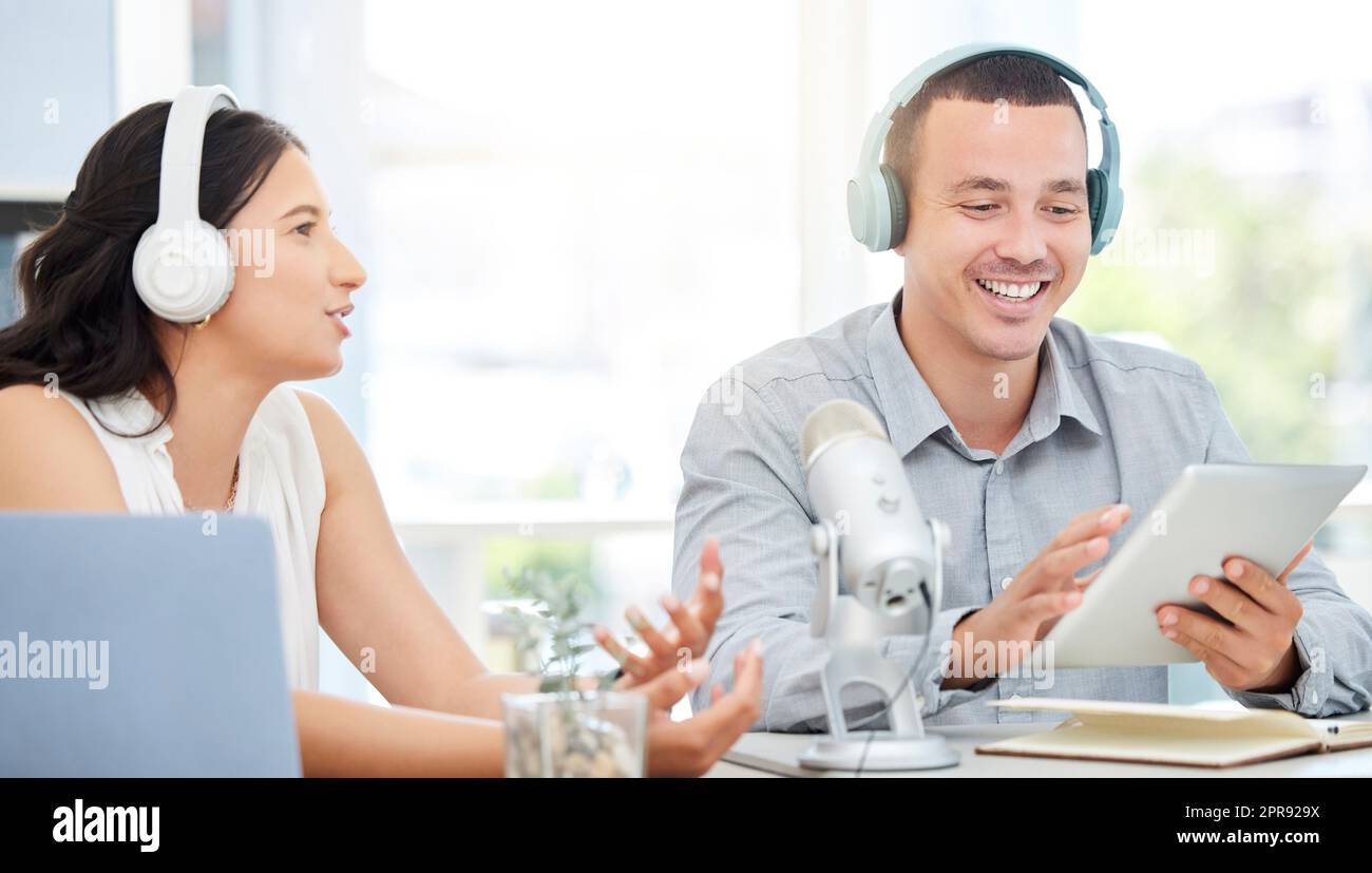 Providing insightful news. a young man and woman doing a broadcast in ...