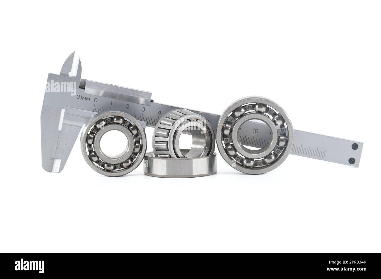 Measure caliper and roller bearings over white Stock Photo - Alamy