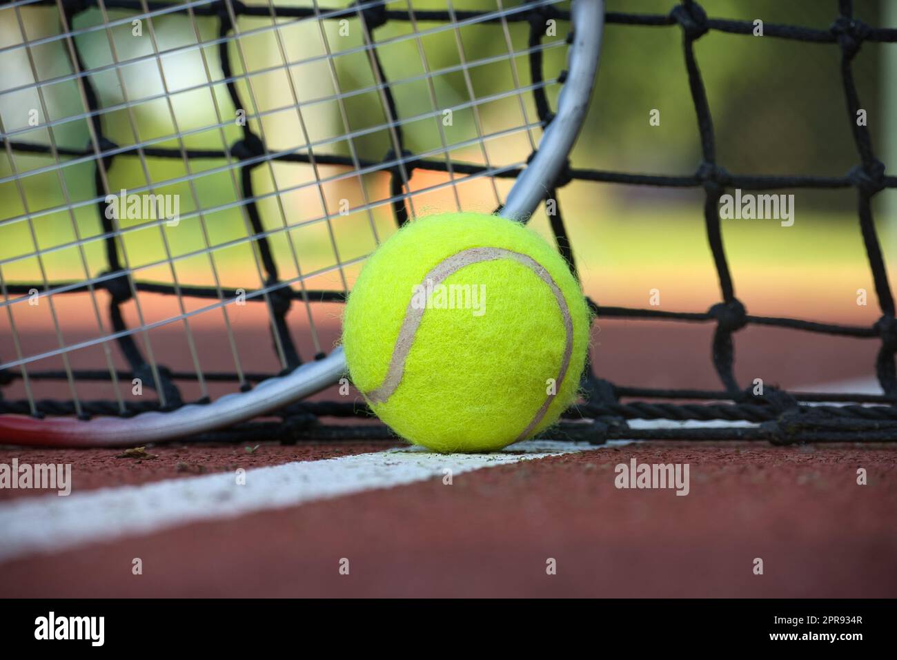 Tennis scene with black net, ball on white line Stock Photo - Alamy