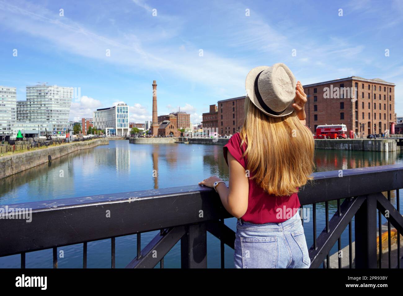 Tourism in Liverpool, UK. Back view of traveler girl on Swing Bridge ...