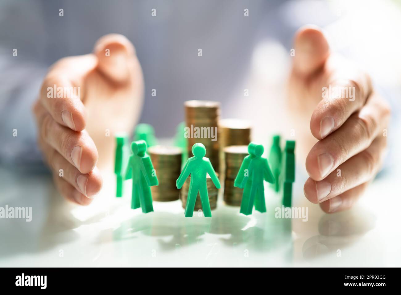 Protecting Blue Human Figures Surrounding Stacked Coins Stock Photo - Alamy