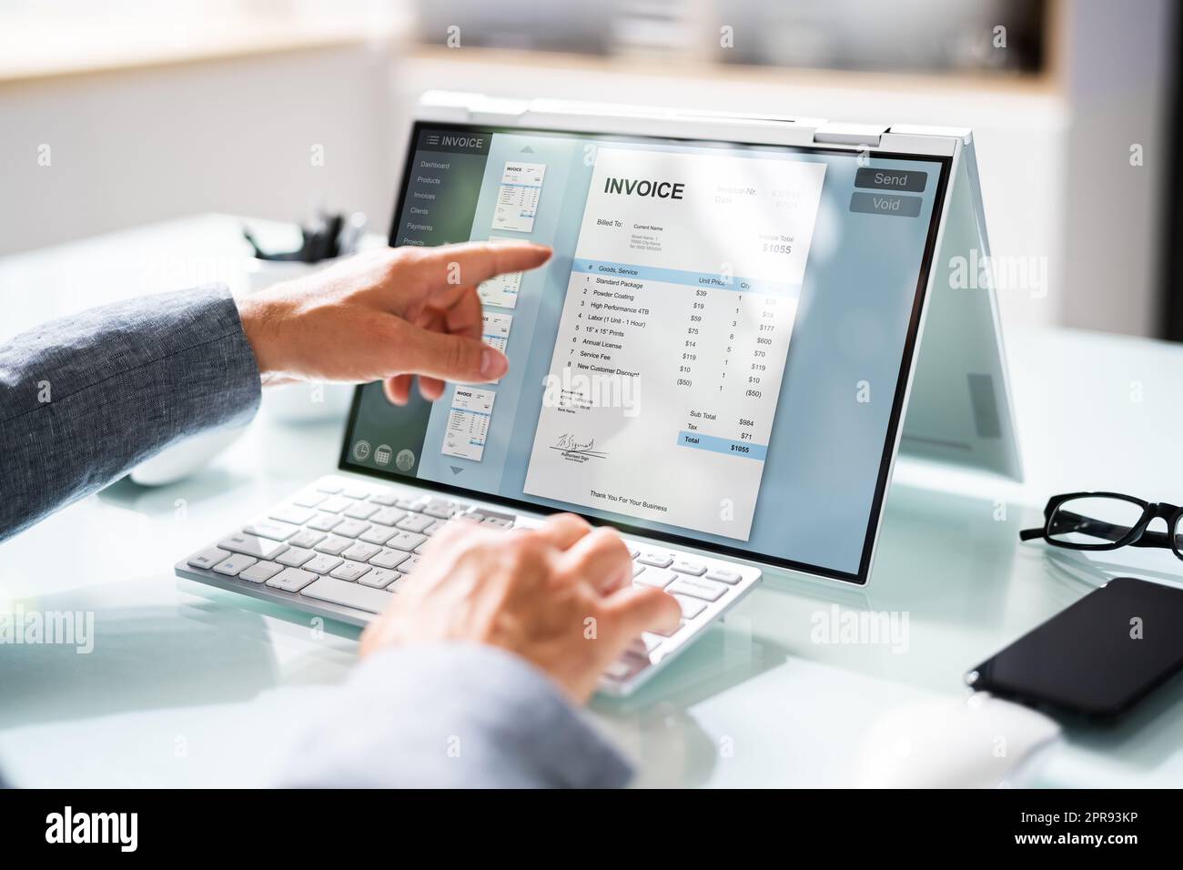 Businessperson Analyzing Invoice On Laptop Stock Photo - Alamy