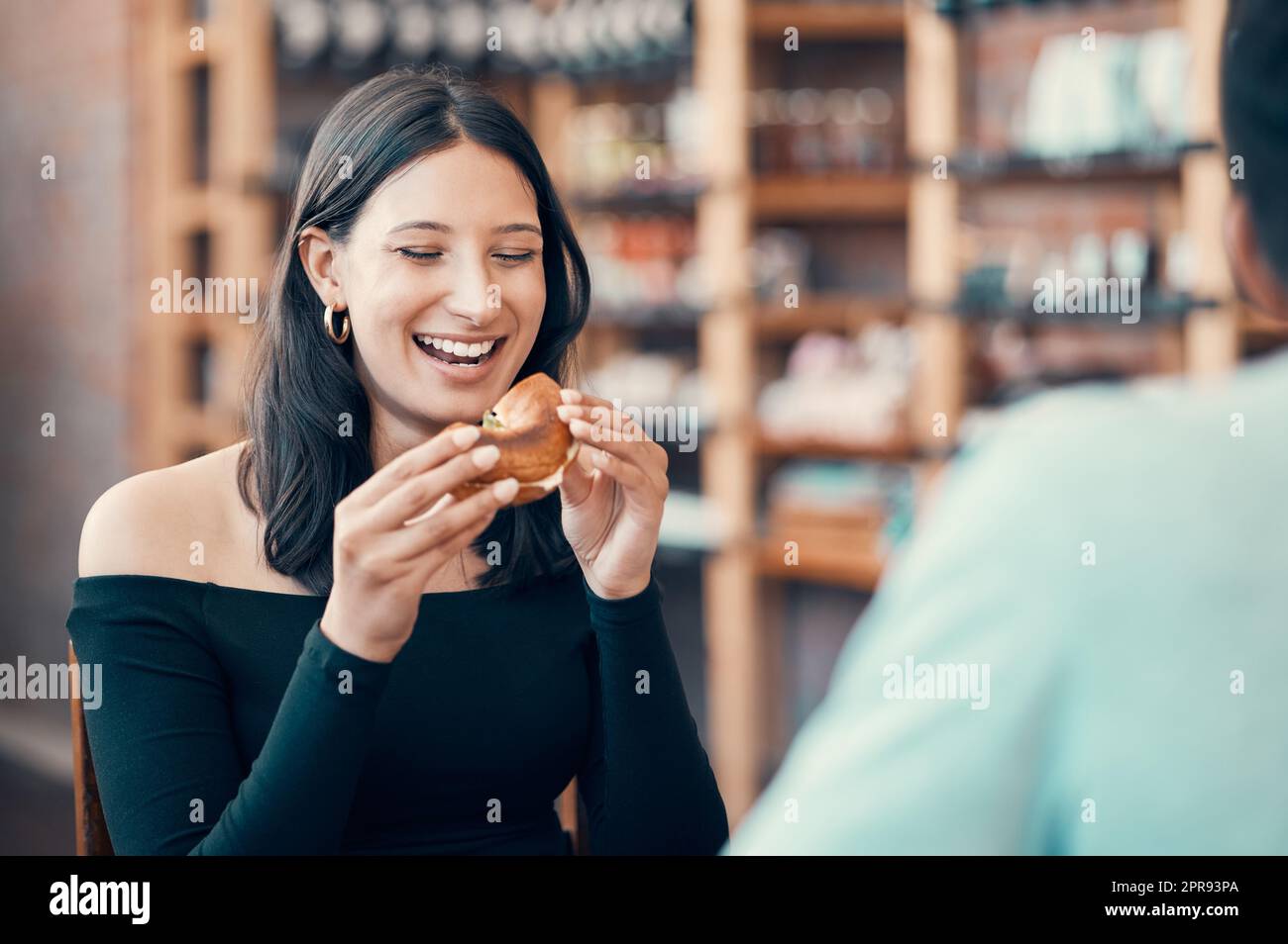 Happy, beautiful and relaxed woman eating on a date at a restaurant ...