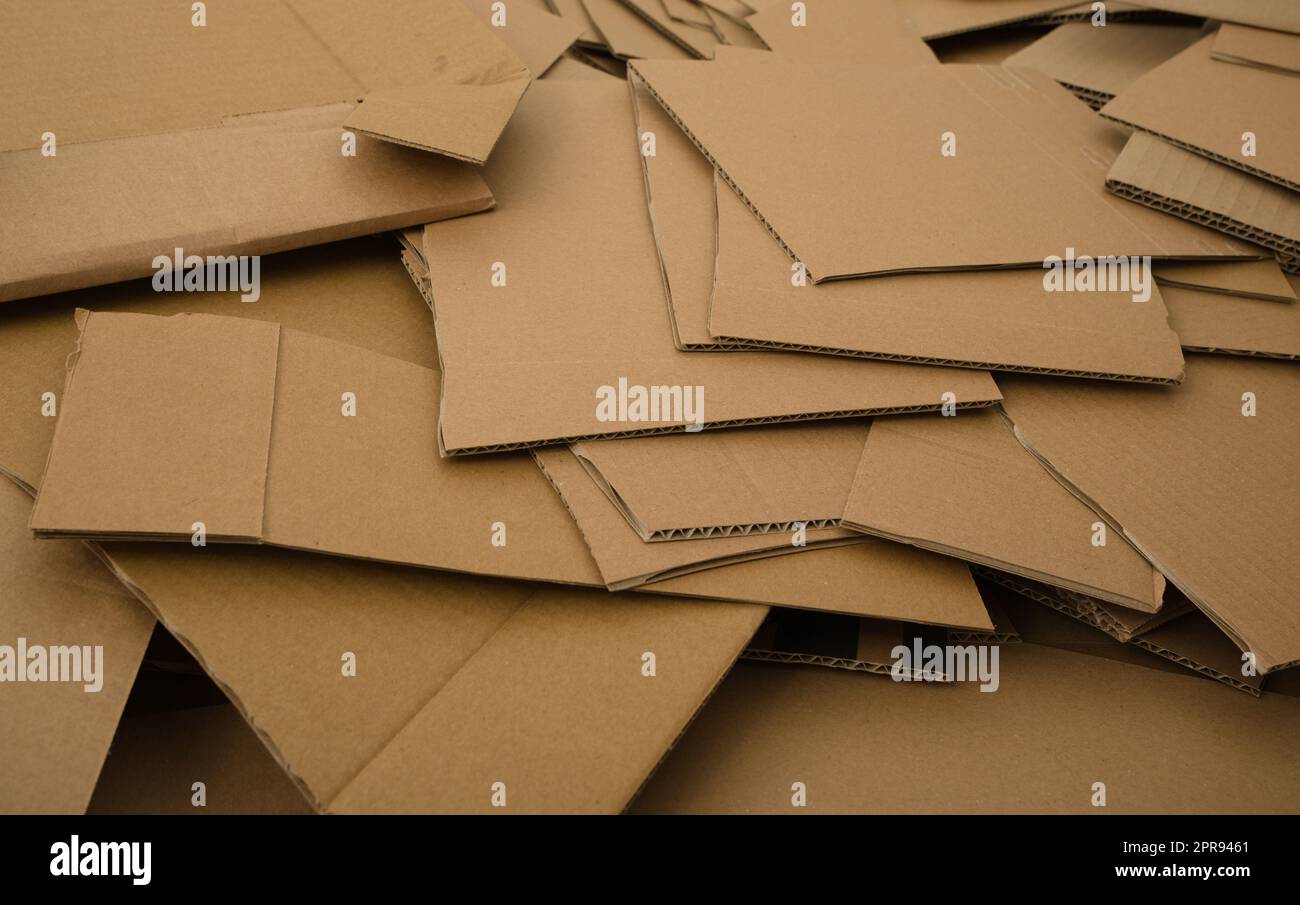 A lot of cut cardboard lying in a large pile. Photo shows the amount of ...