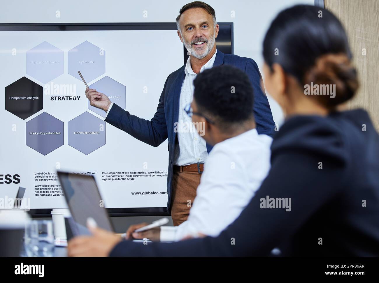 Explaining key strategies to his team. a mature businessman giving a ... Explaining key strategies to his team. a mature businessman giving a ...