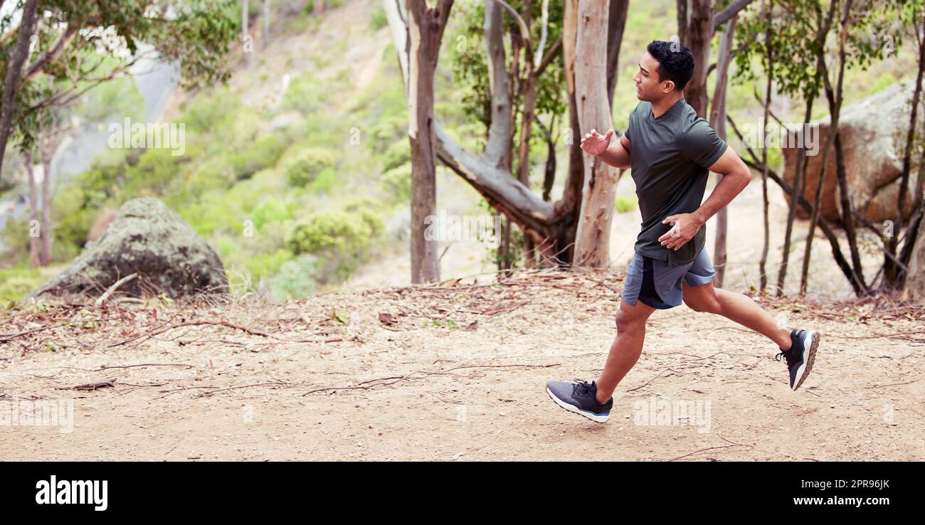 A refreshing run is just what I needed. a sporty young man running ...