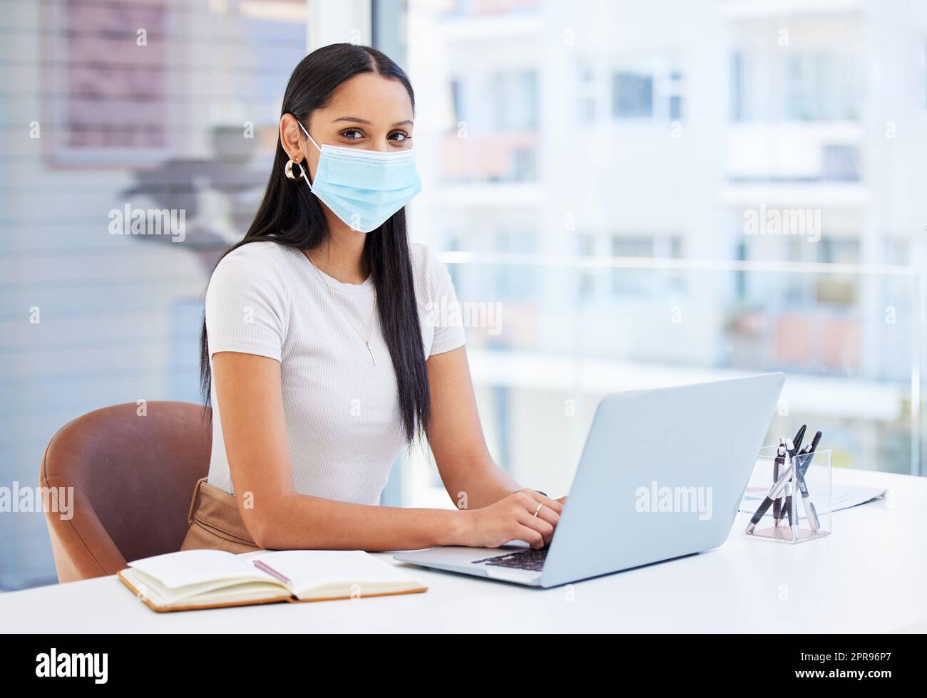 Keep it clean keep it safe. a young businesswoman using her laptop at ...