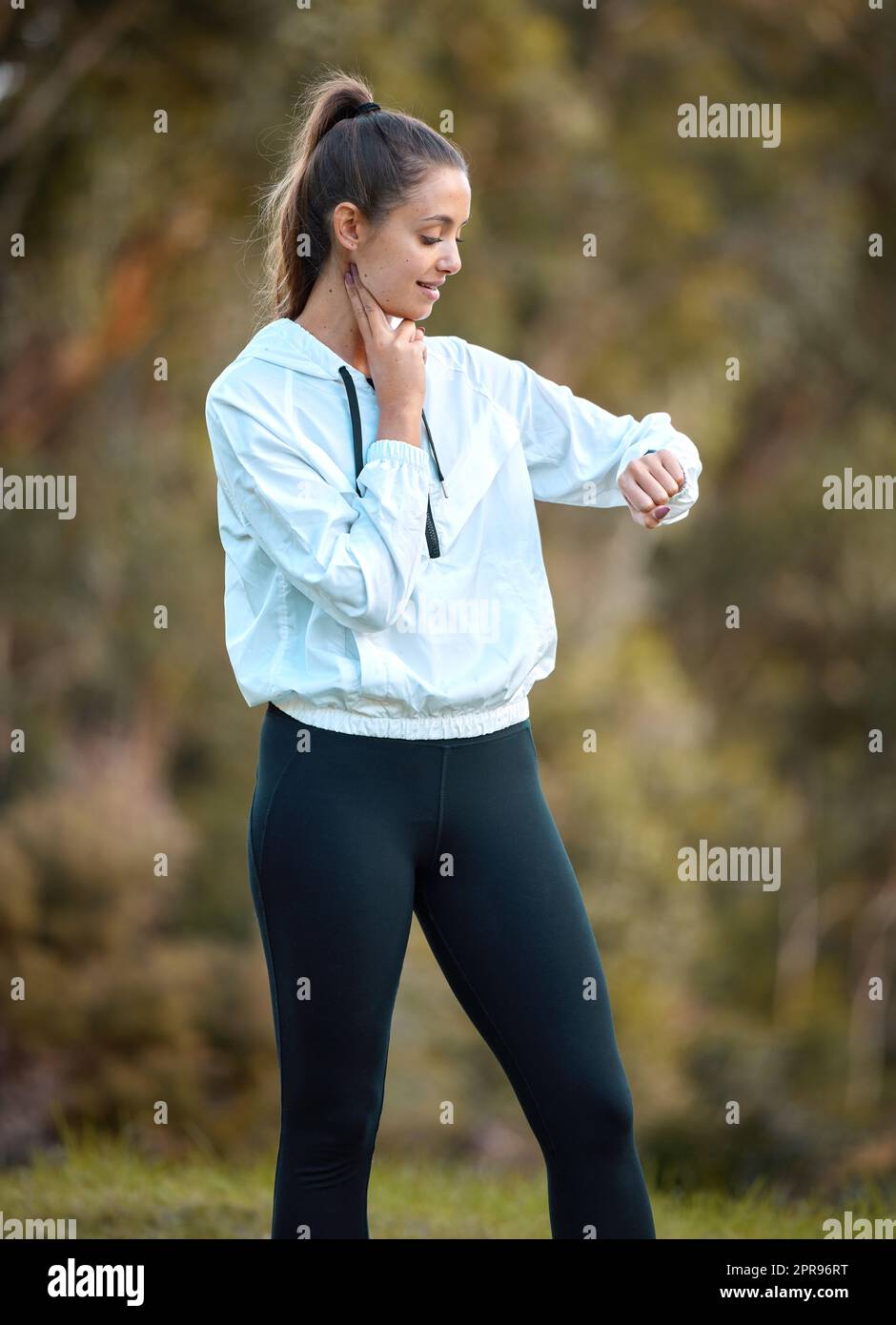 Tracking her intensity during a workout. a sporty young woman checking ...
