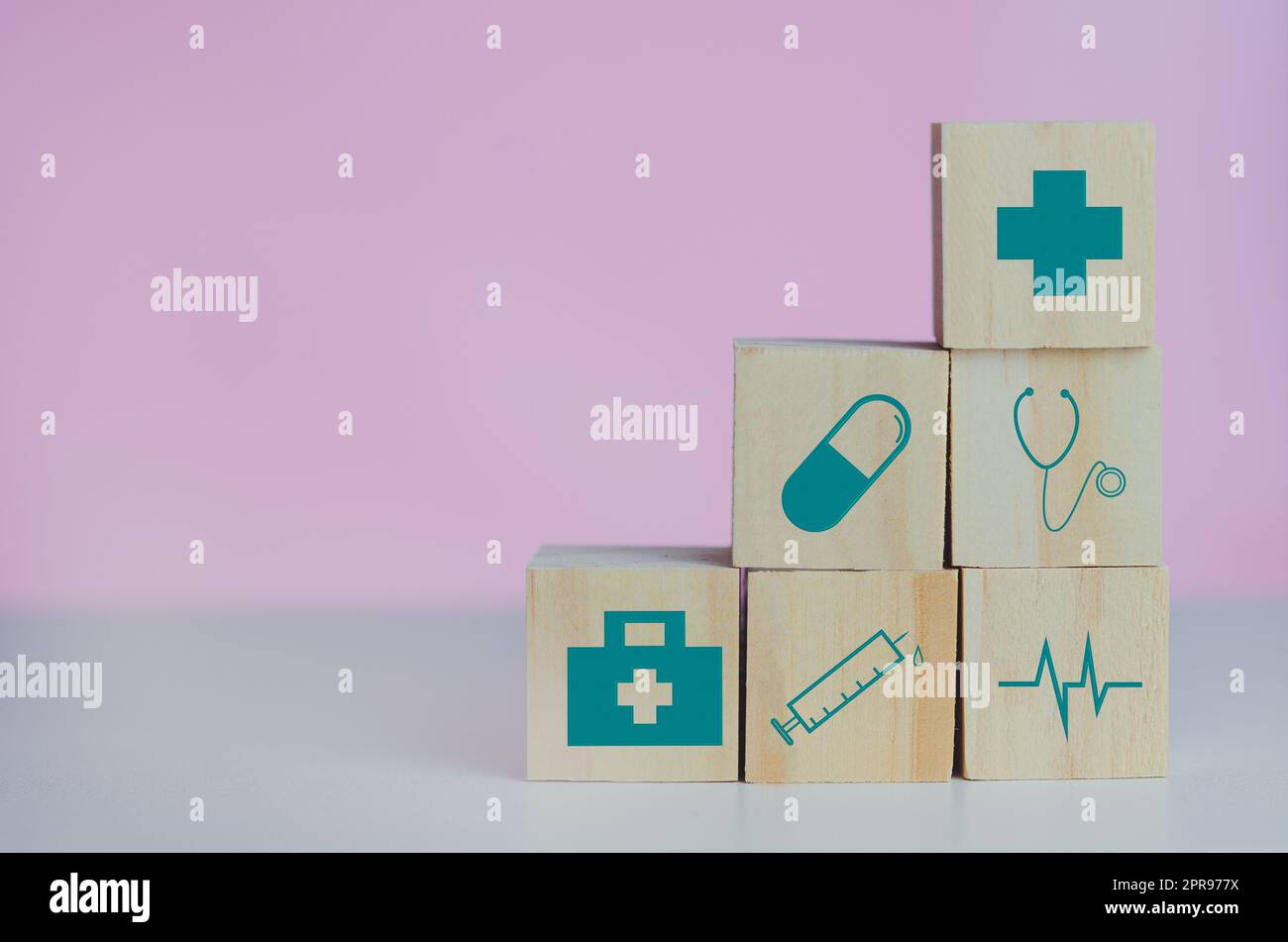 Wooden cubes block with insurance health car medical symbol on the pink ...