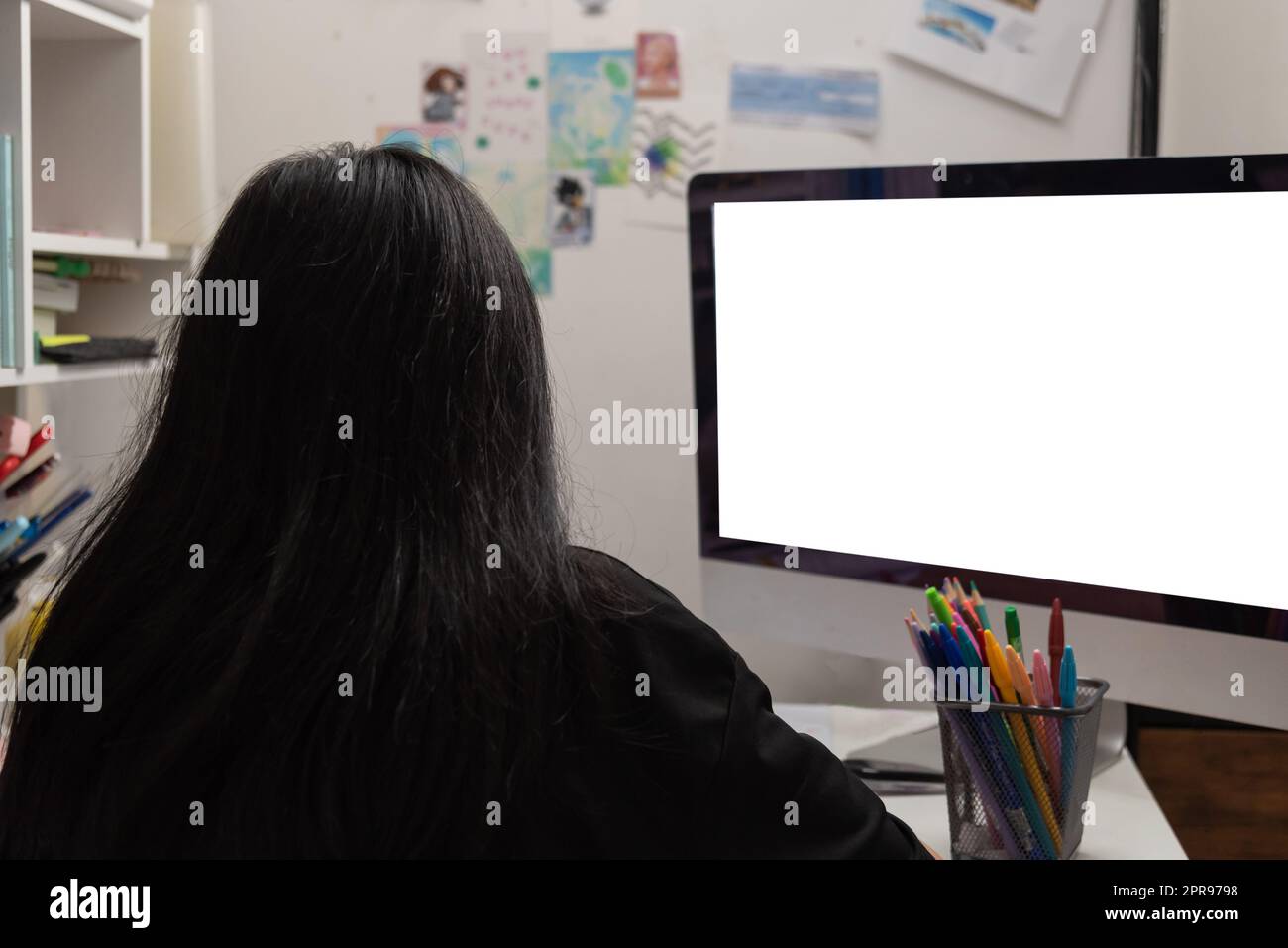 Asian student girl is writing homework and reading book at desk Stock ...