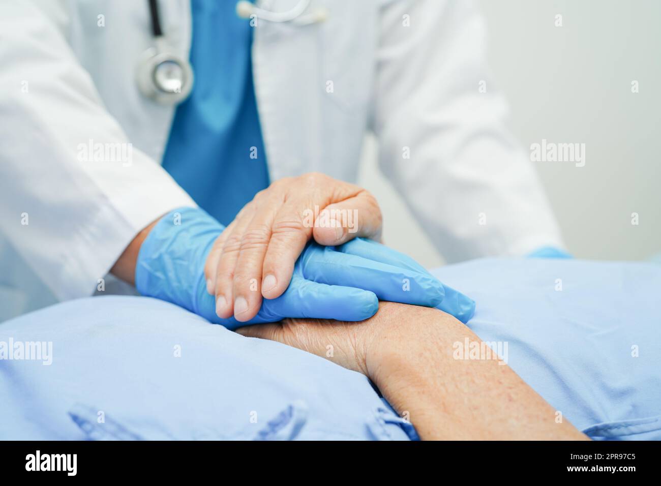Doctor holding hands Asian elderly woman patient, help and care in ...