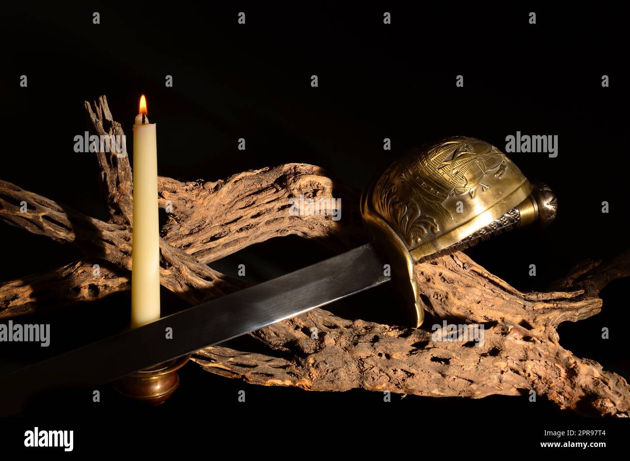 Old saber sword with candle and cholla Stock Photo - Alamy