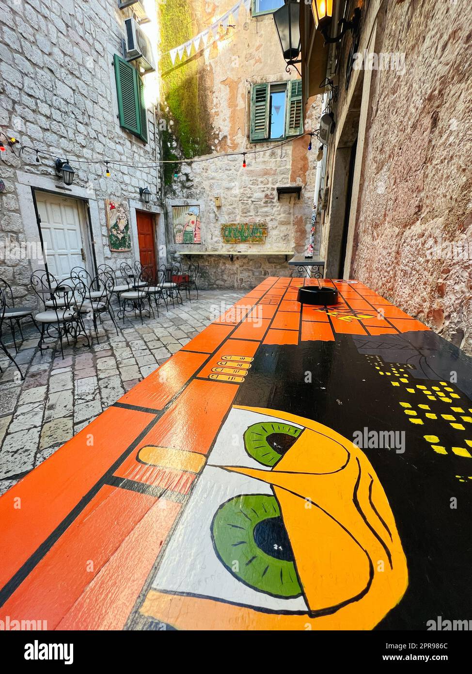 Long table with multi-colored graffiti in the courtyard of an old ...