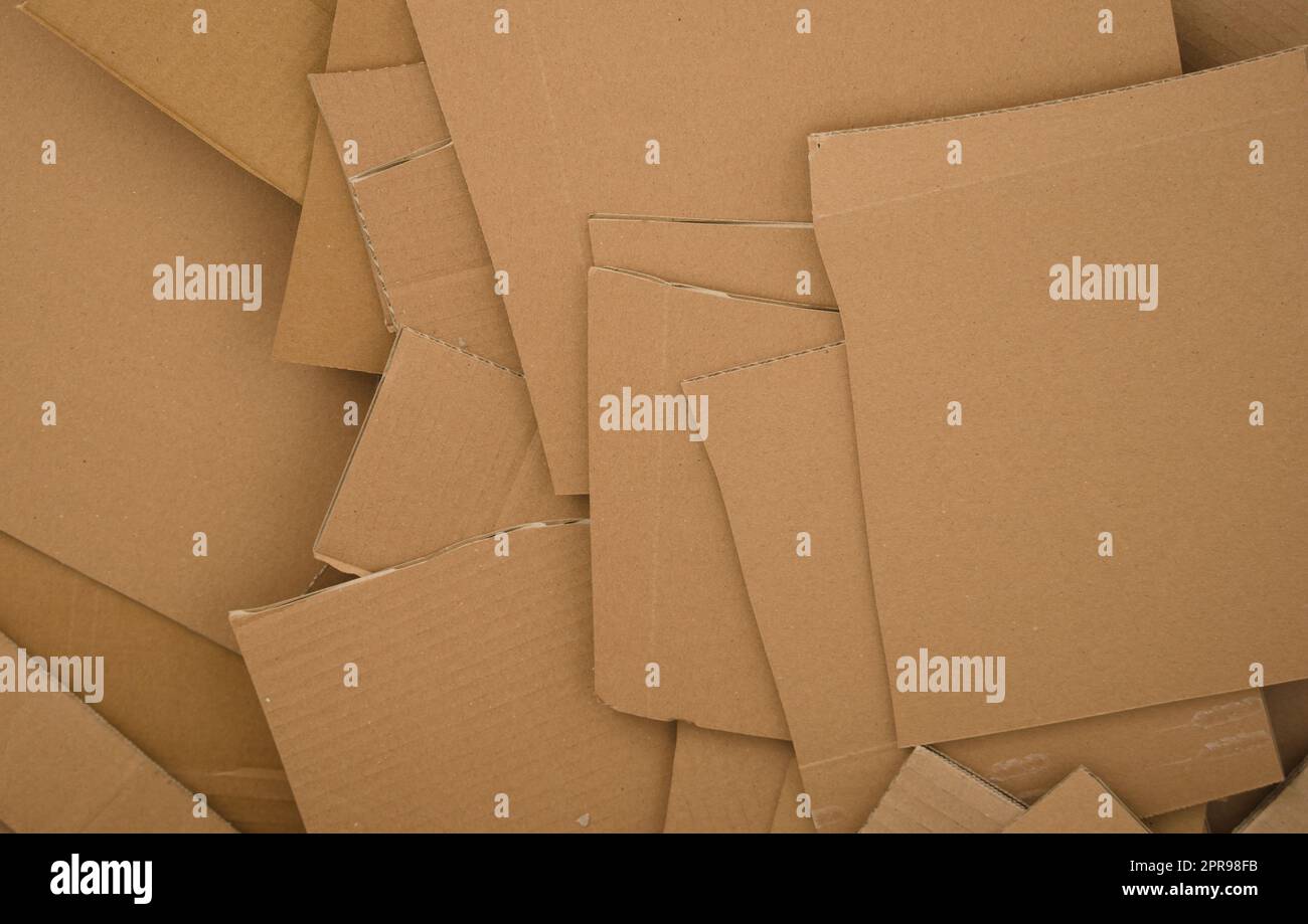 A lot of cut cardboard lying in a large pile. Photo shows the amount of ...