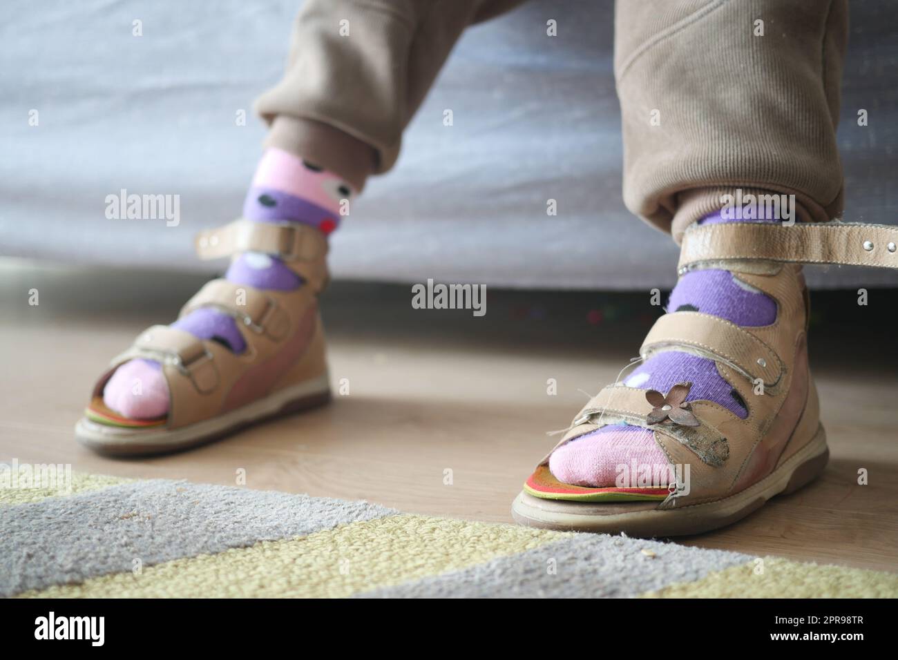 Child cerebral palsy disability, legs orthosis Stock Photo - Alamy