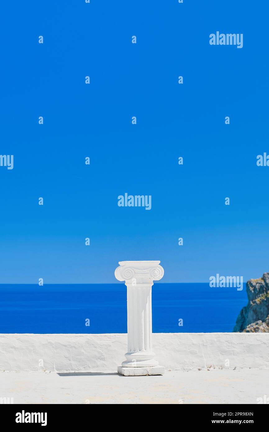 Vertical shot of an antique column on the roof of a house. View of the ...