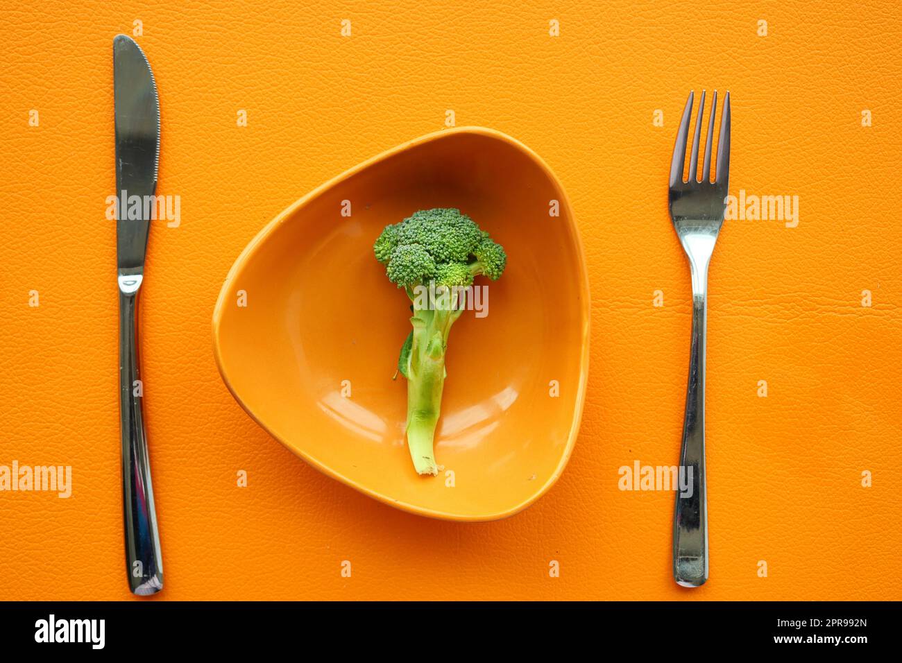 picking raw broccoli with fork Stock Photo - Alamy