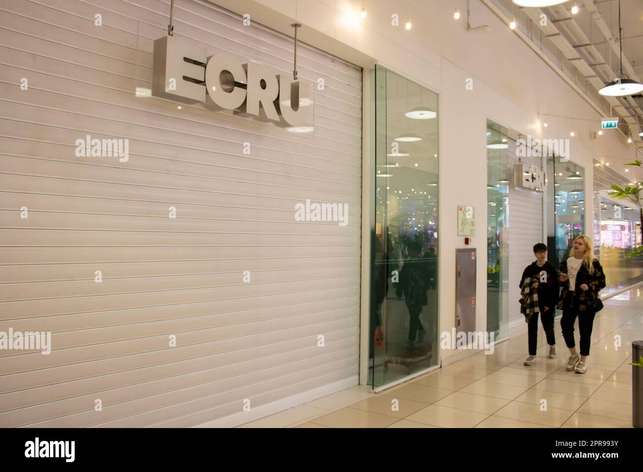People walk past a new Ecru boutique in a shopping mall. Former Bershka stores in Russia that ...