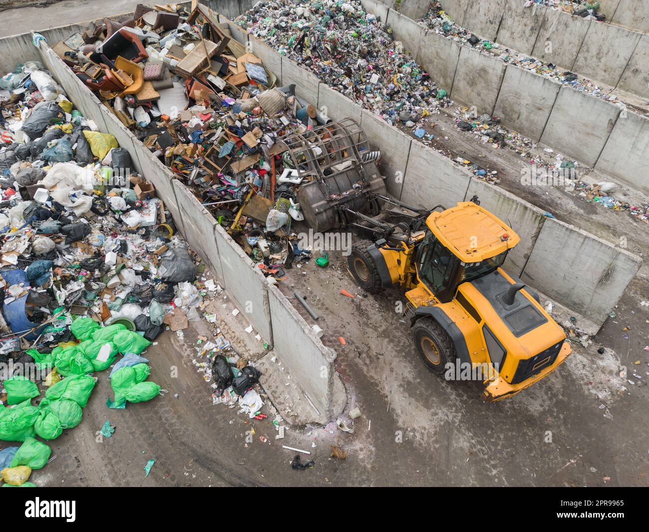 Handling construction waste on the landfill site, skid steer loader ...