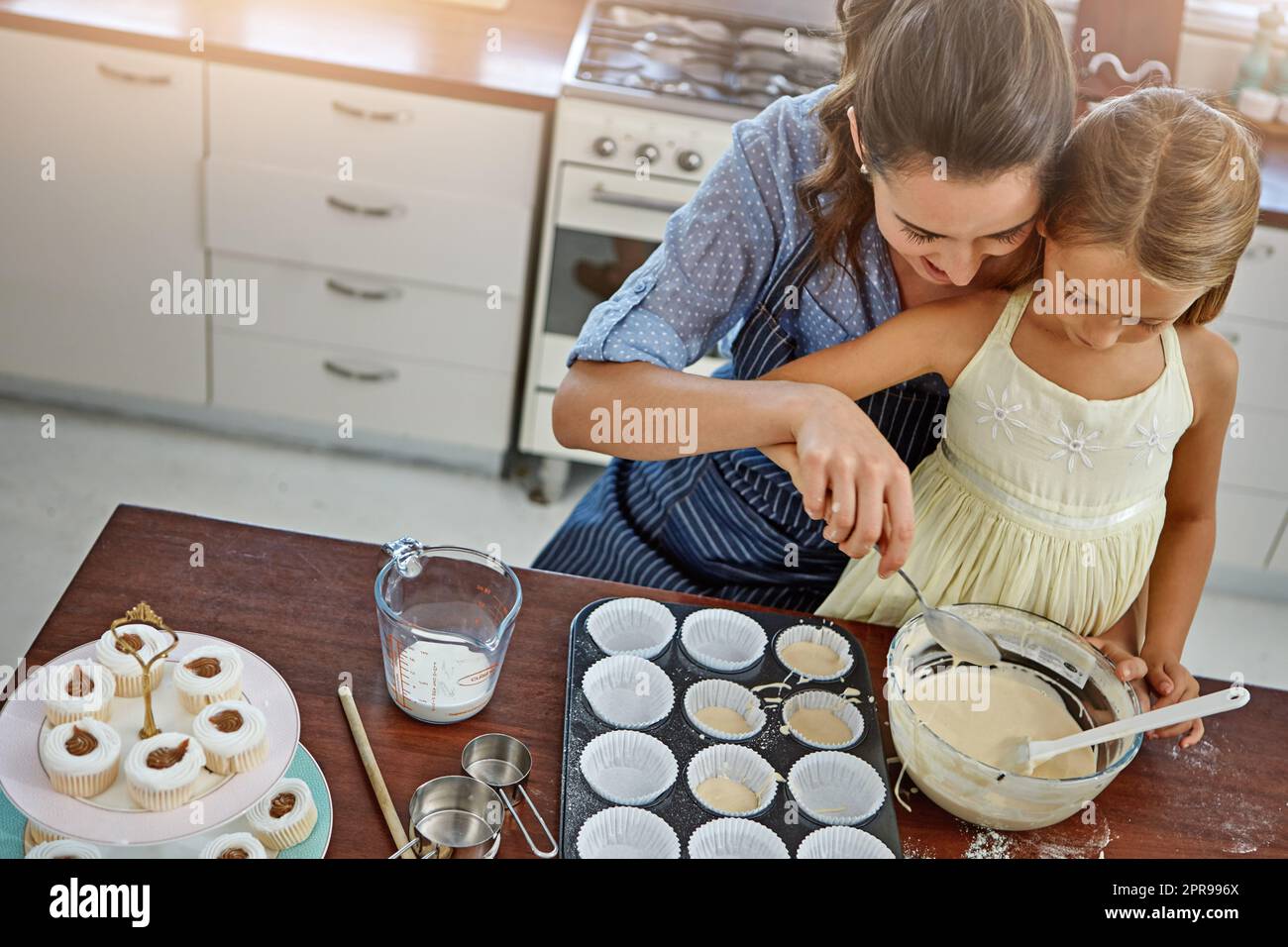 Learning the basics of baking. a mother and her daughter baking in the ...