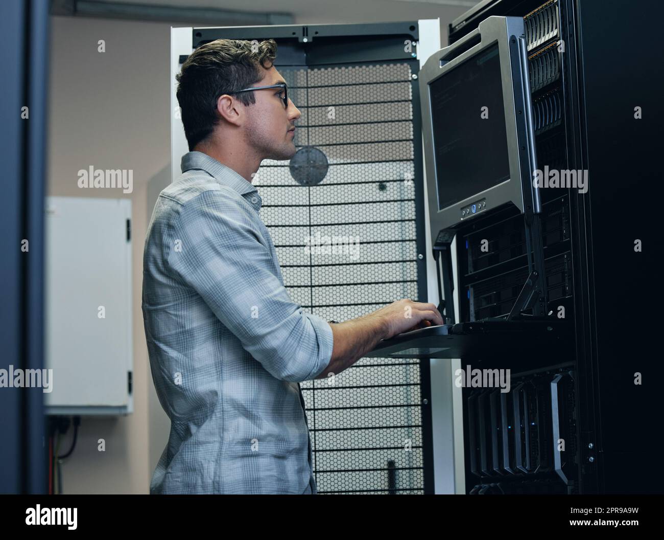 Checking out the code. a handsome young male programmer working on a ... Checking out the code. a handsome young male programmer working on a ...