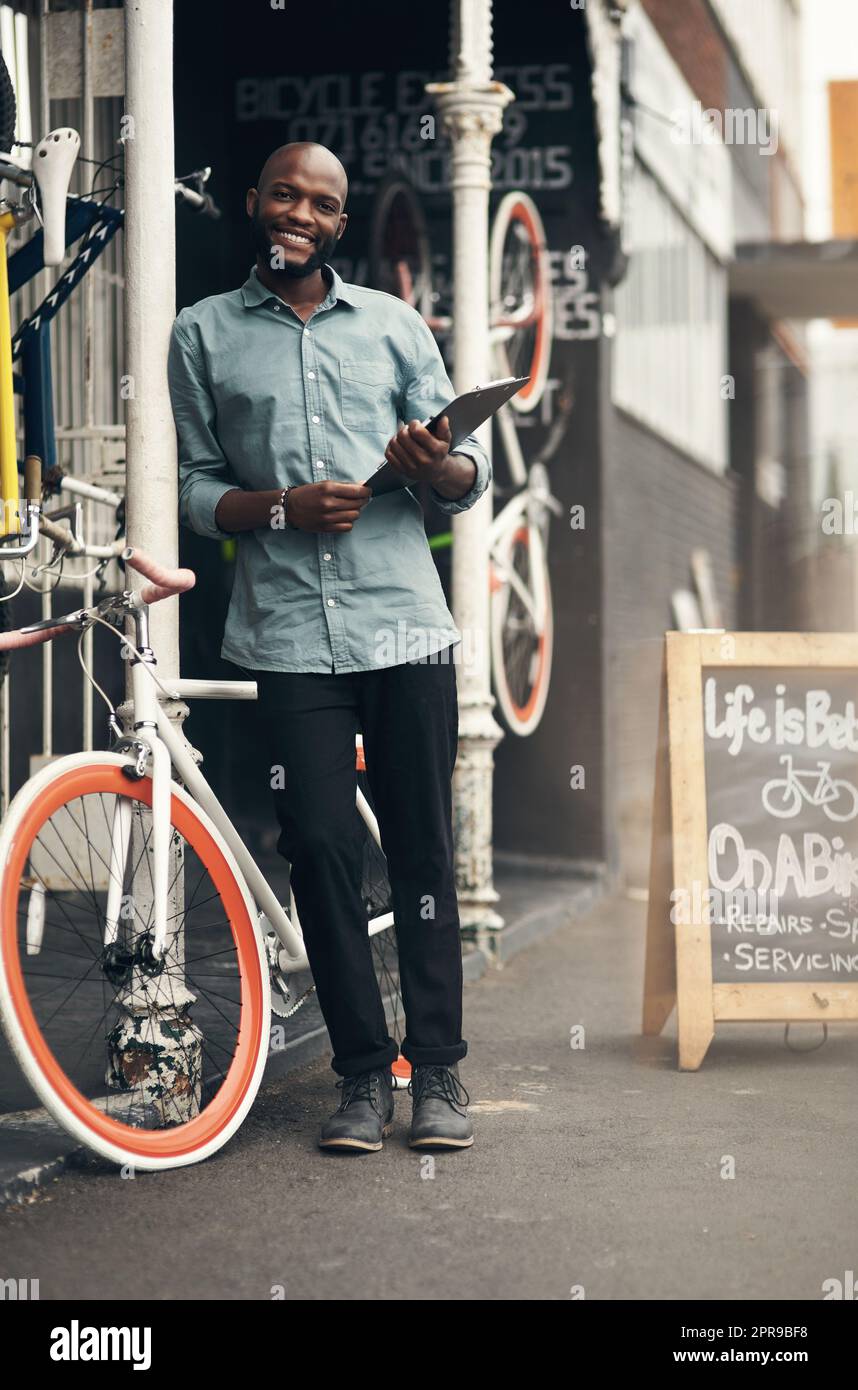 Portrait man standing bike shop hi-res stock photography and images - Alamy