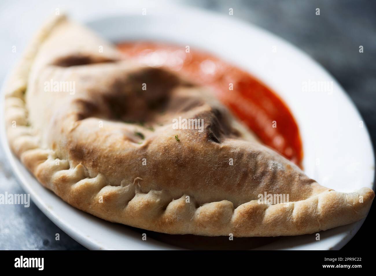 italian calzone folded pizza Stock Photo - Alamy