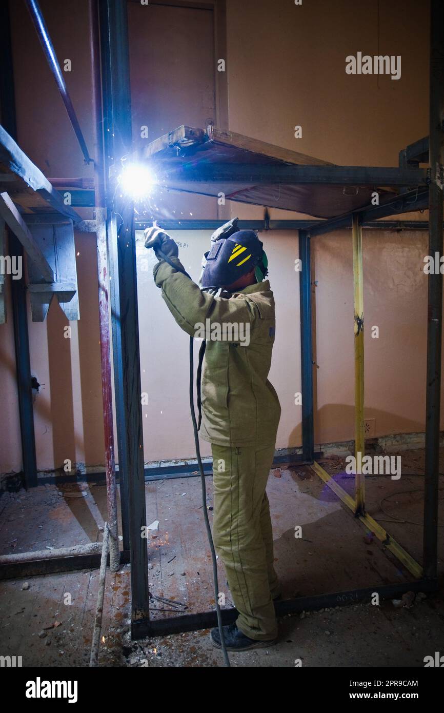 Welder in mask welding metal construction on open air Stock Photo - Alamy