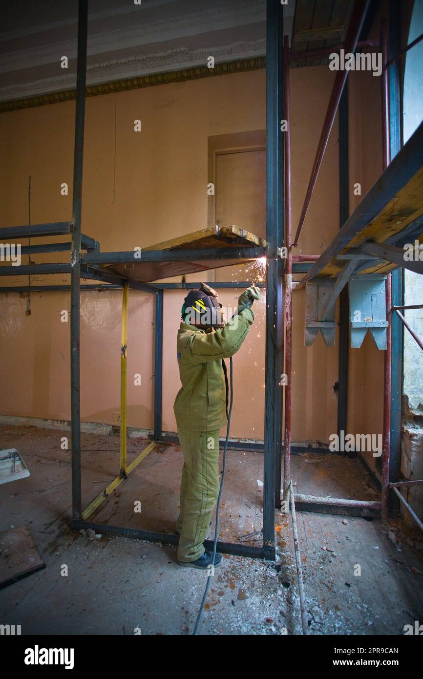 Welder in mask welding metal construction on open air Stock Photo - Alamy