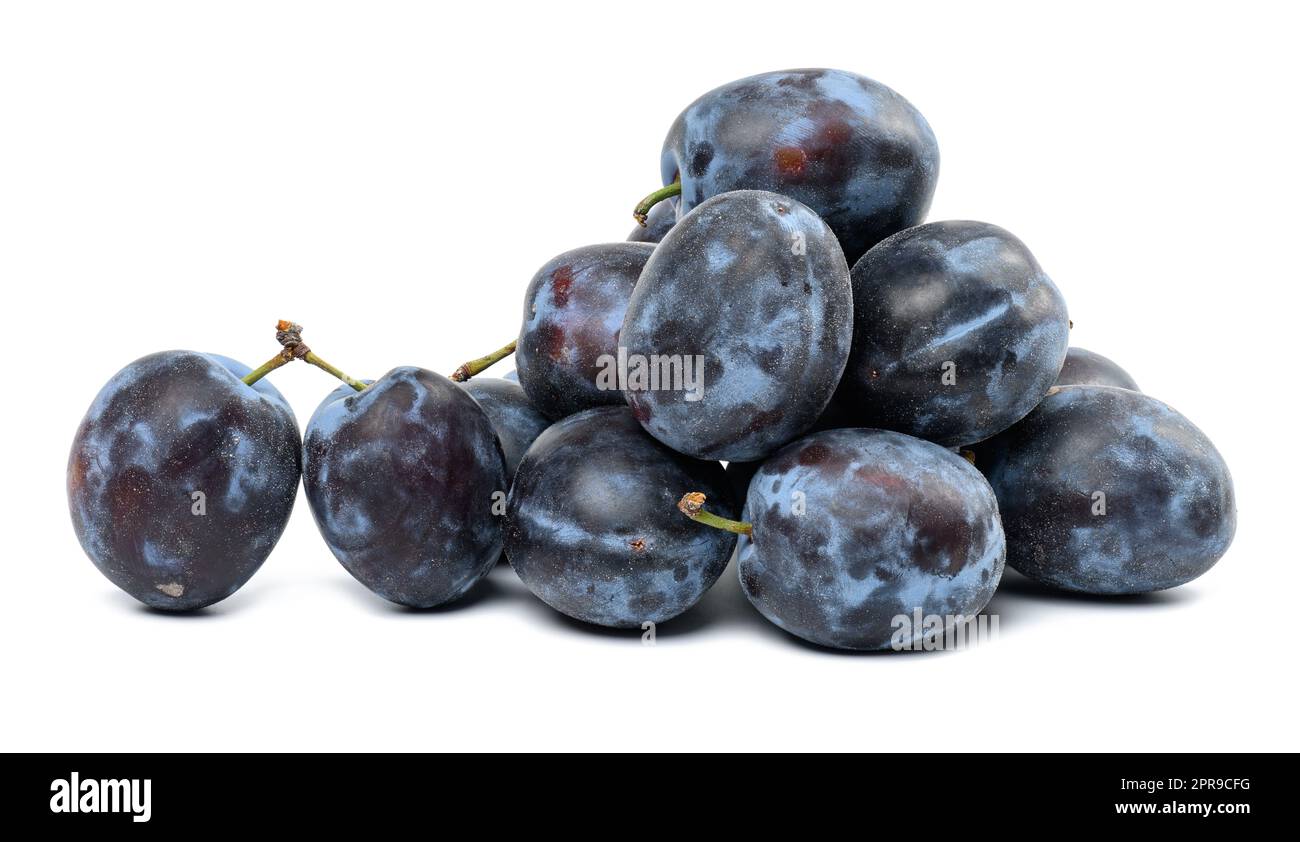 Stack of ripe blue plums on white isolated background Stock Photo - Alamy