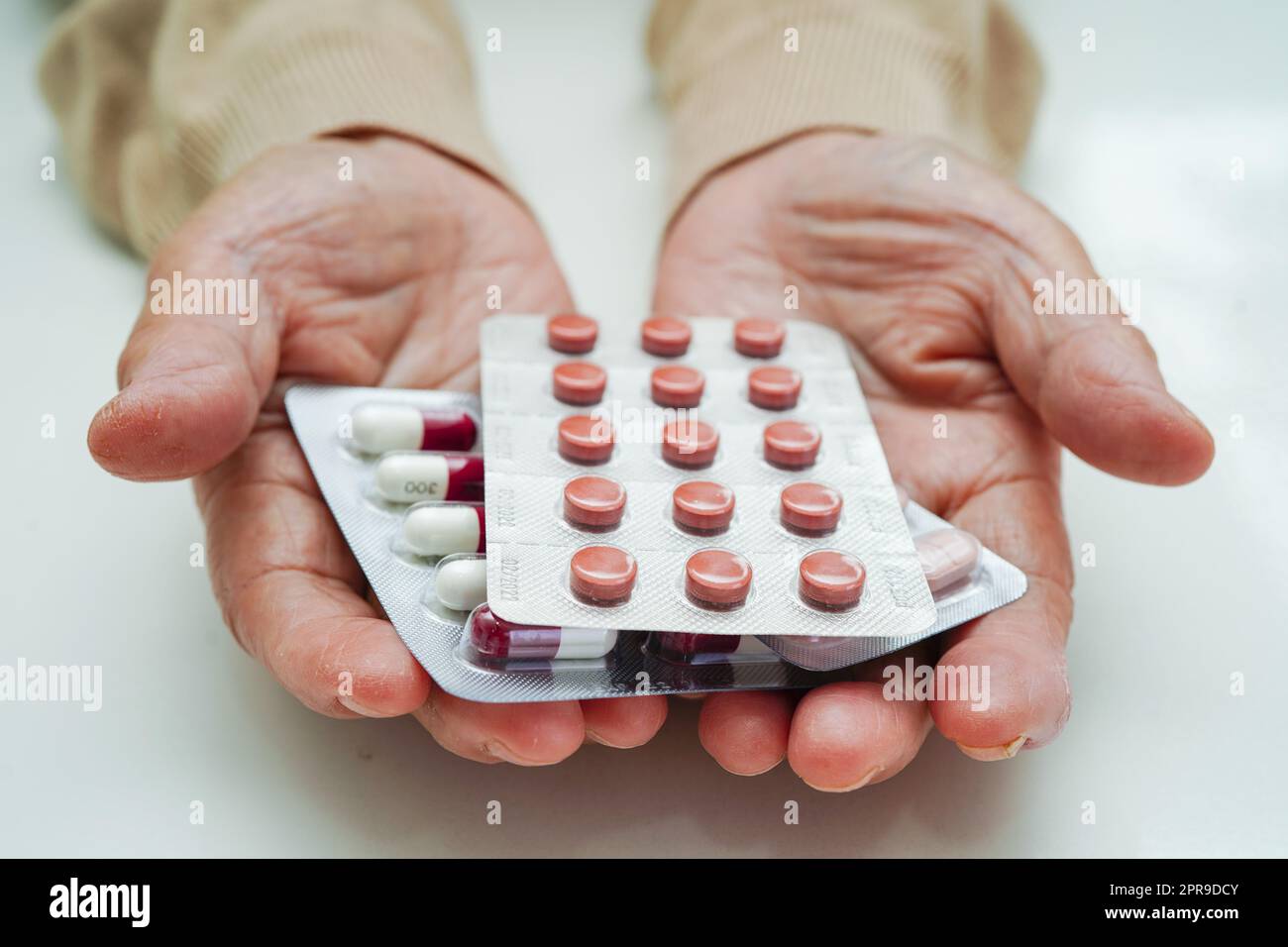 Asian elderly woman holding pill drug in hand, strong healthy medical ...