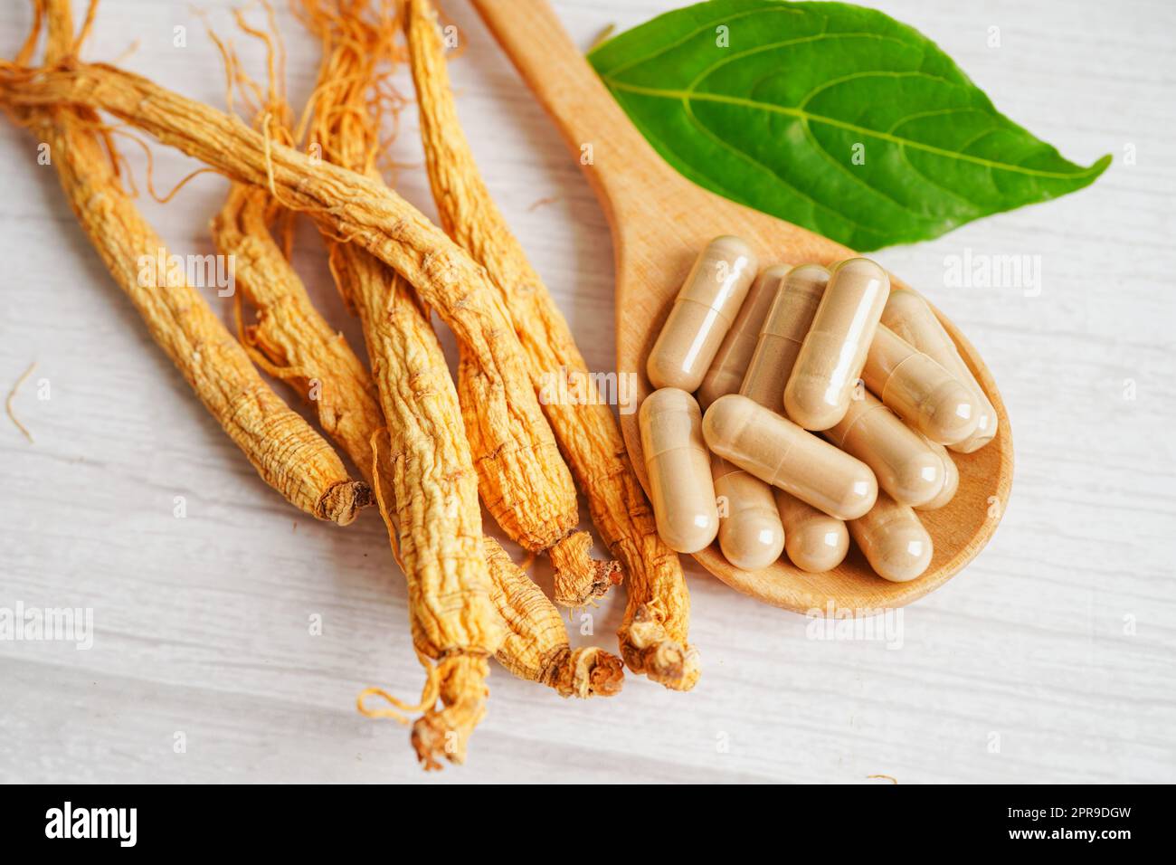 Ginseng roots and green leaf, healthy food Stock Photo - Alamy
