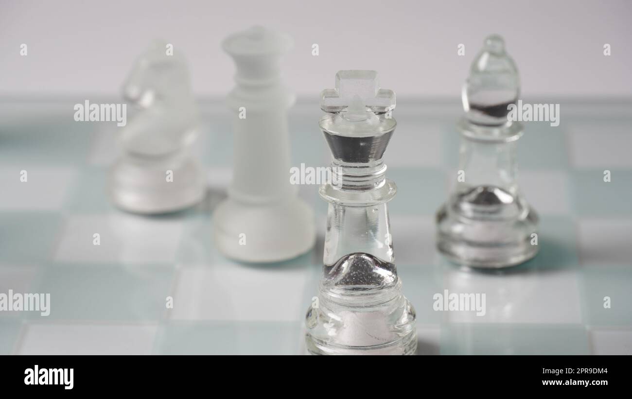 Transparent chess figures, on starting position, on reflective chess ...