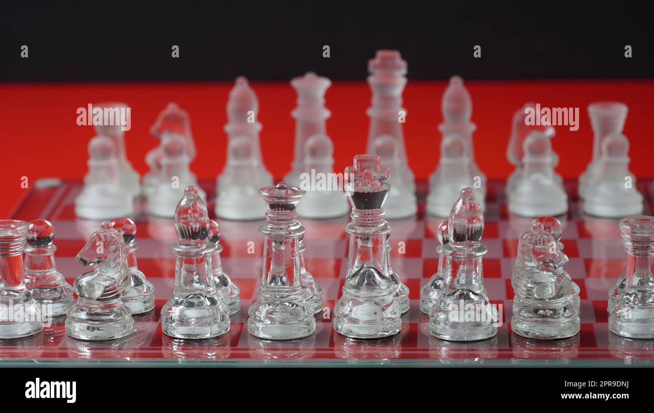 Transparent chess figures, on starting position, on reflective chess ...