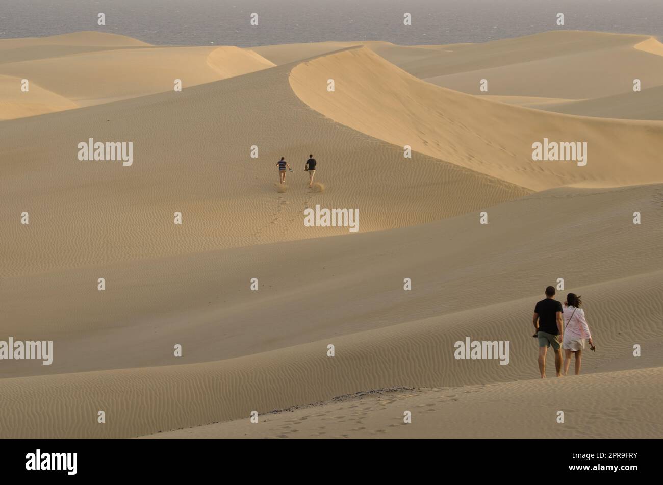 People walking in sand dunes Stock Photo - Alamy