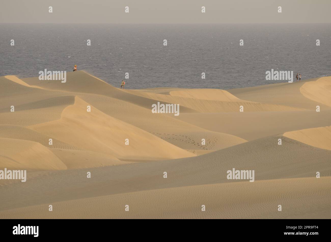 People in sand dunes Stock Photo - Alamy