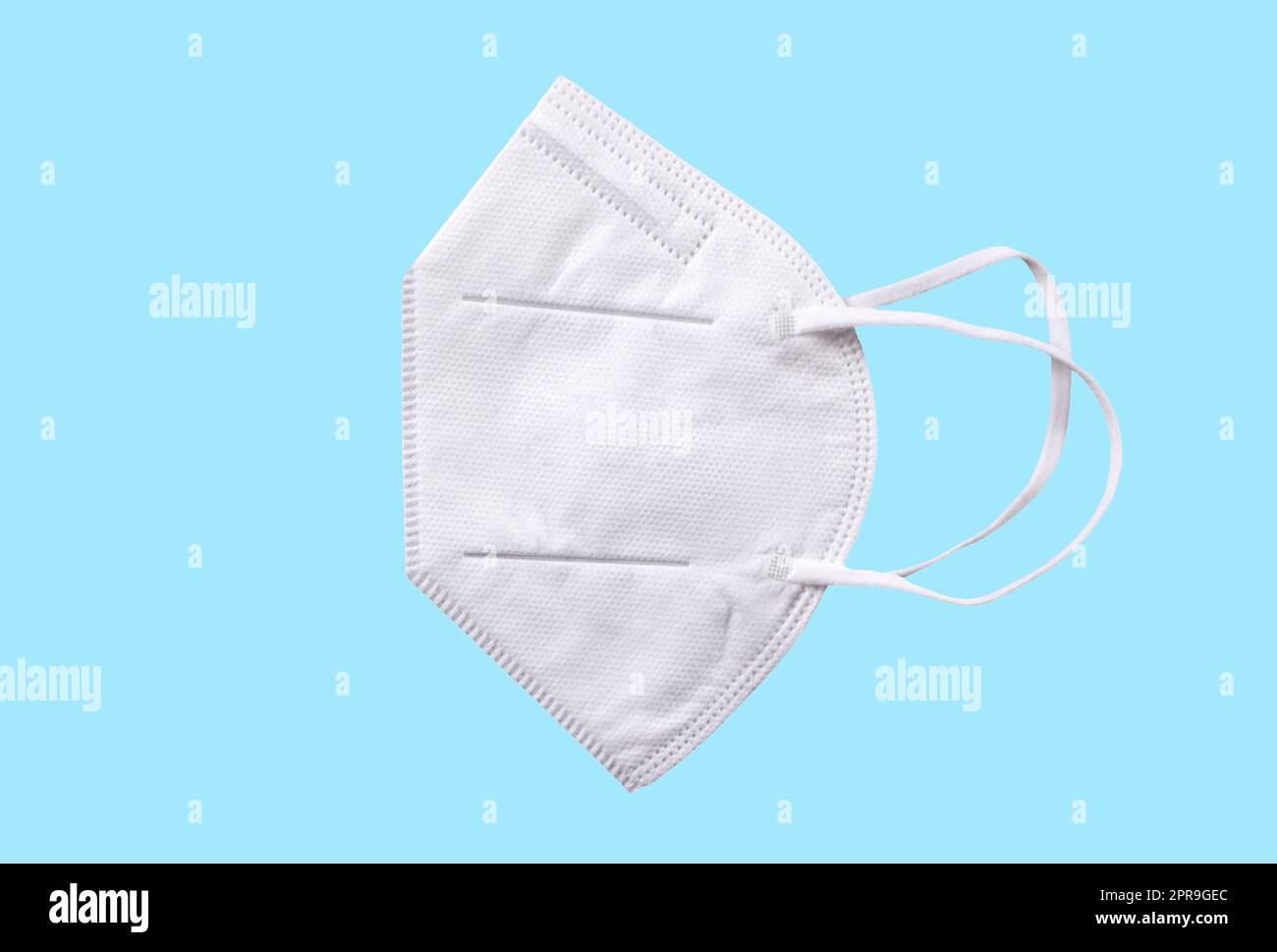 FFP 2 mask filtering face piece isolated on light blue background Stock ...