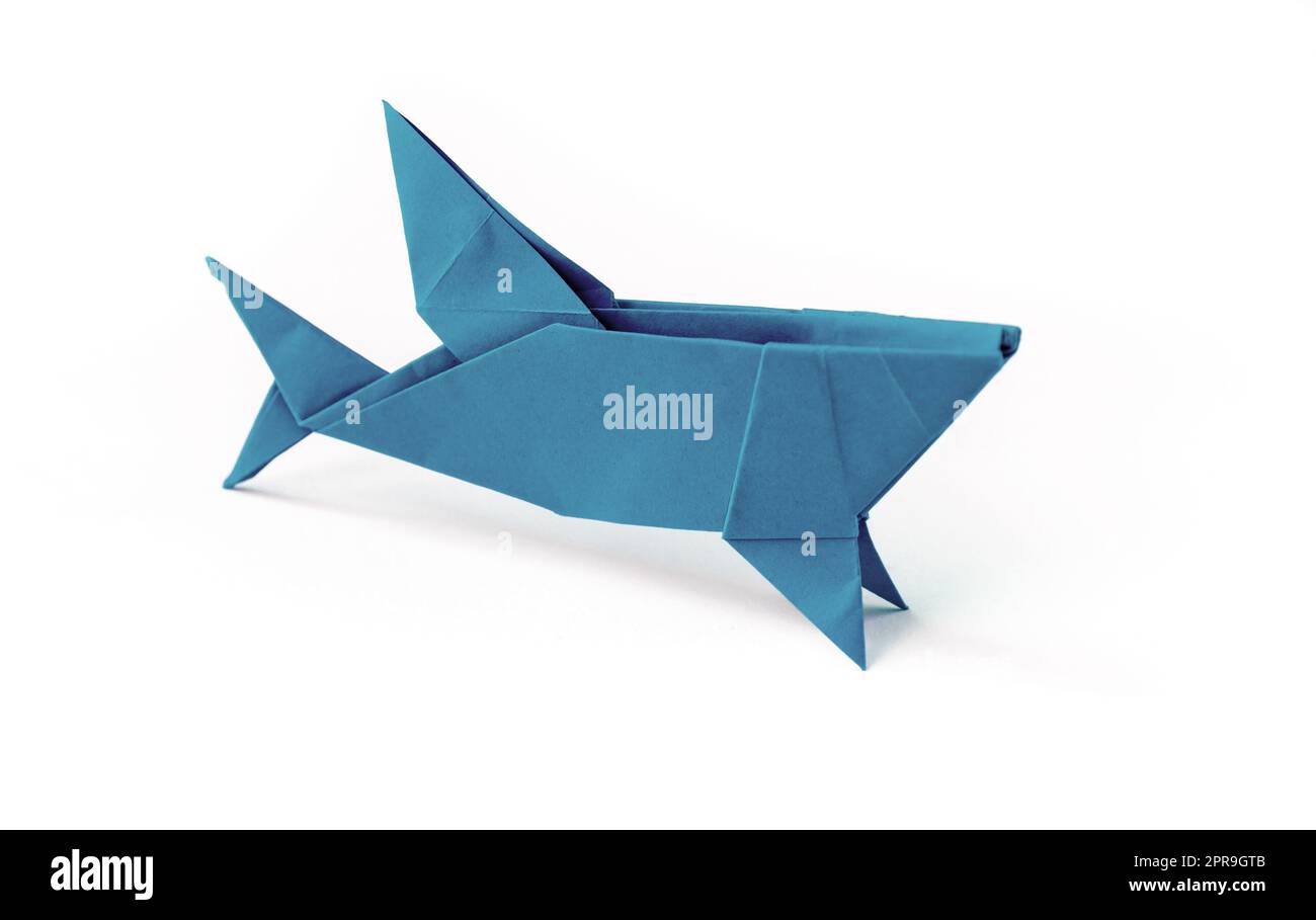 Blue paper shark origami isolated on a white background Stock Photo - Alamy