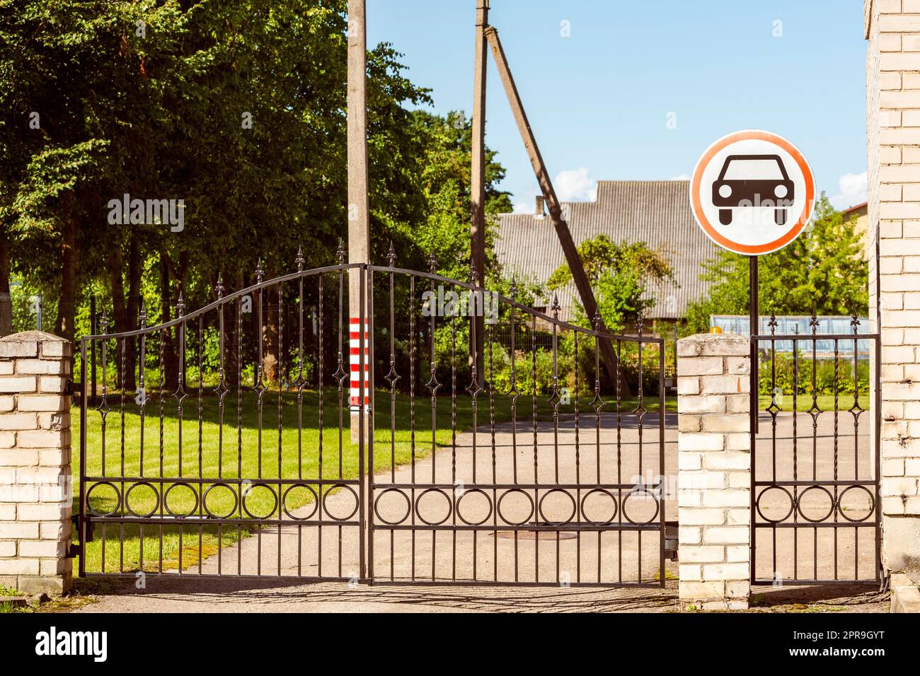 Metal gates and road sign prohibiting entry for transport Stock Photo ...