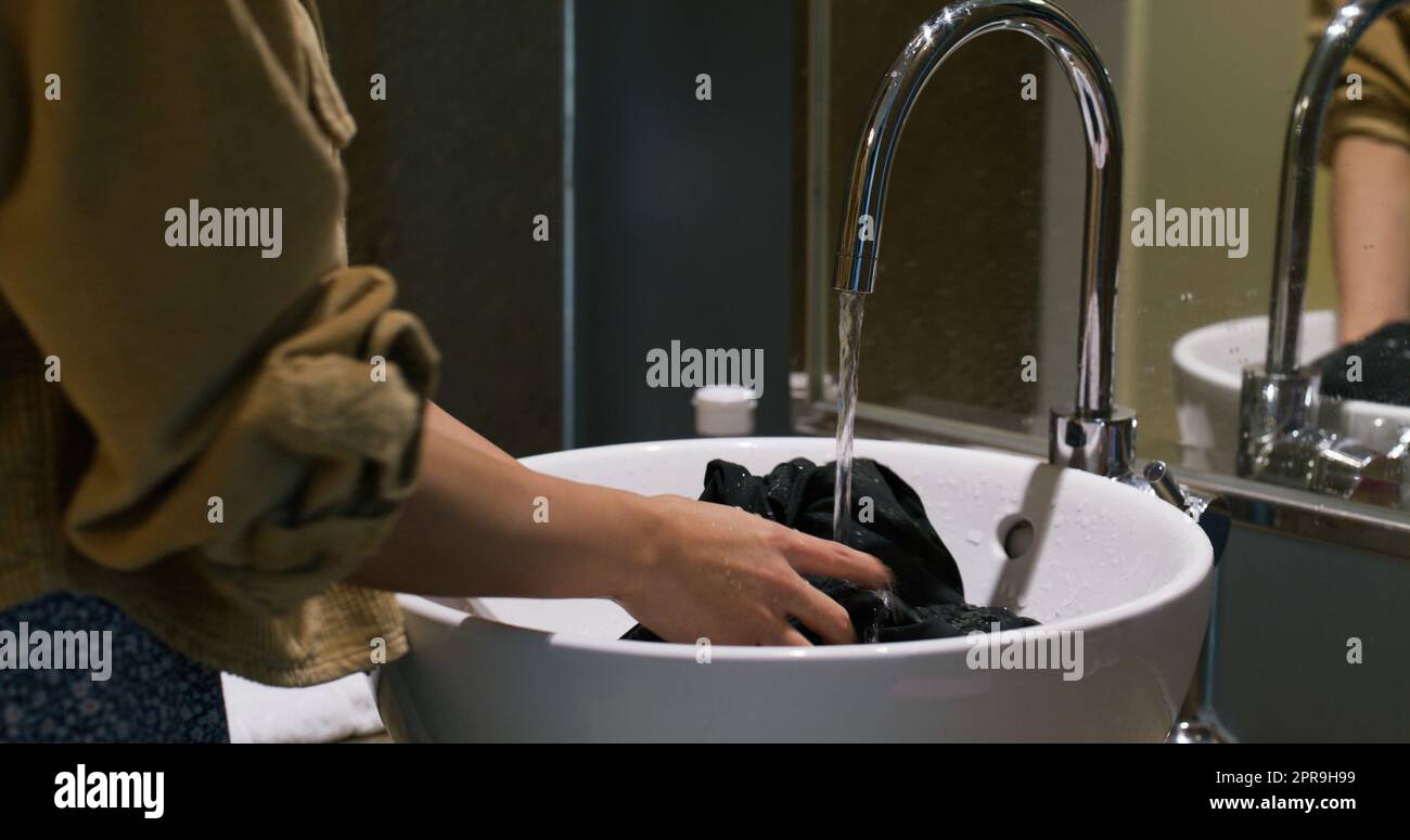 Woman wash her clothes in basin Stock Photo - Alamy