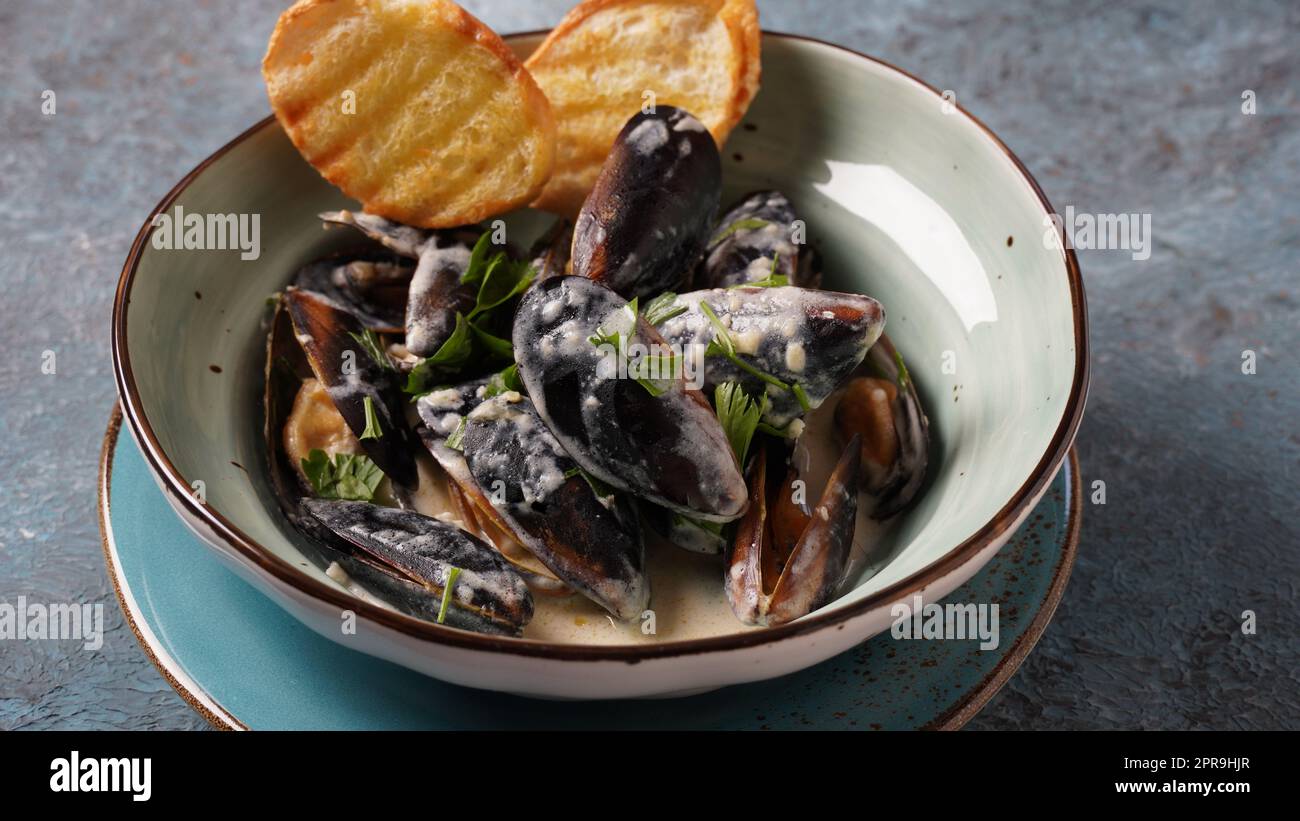 Blue mussels stewed in cream wine sauce with garlic and herbs. Italian ...