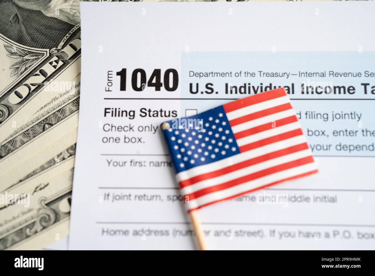 Tax Return form 1040 with USA America flag and dollar banknote, U.S ...