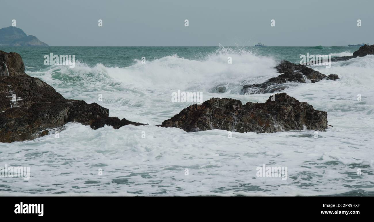 Tropical island with big sea wave Stock Photo - Alamy
