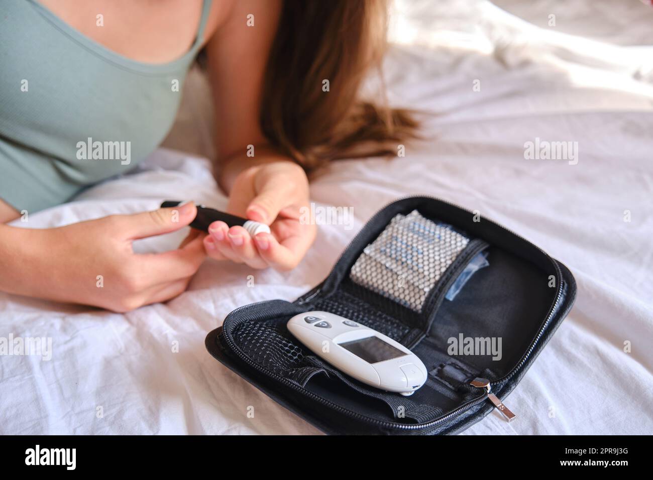 The child is preparing to measure blood sugar with a glucometer ...