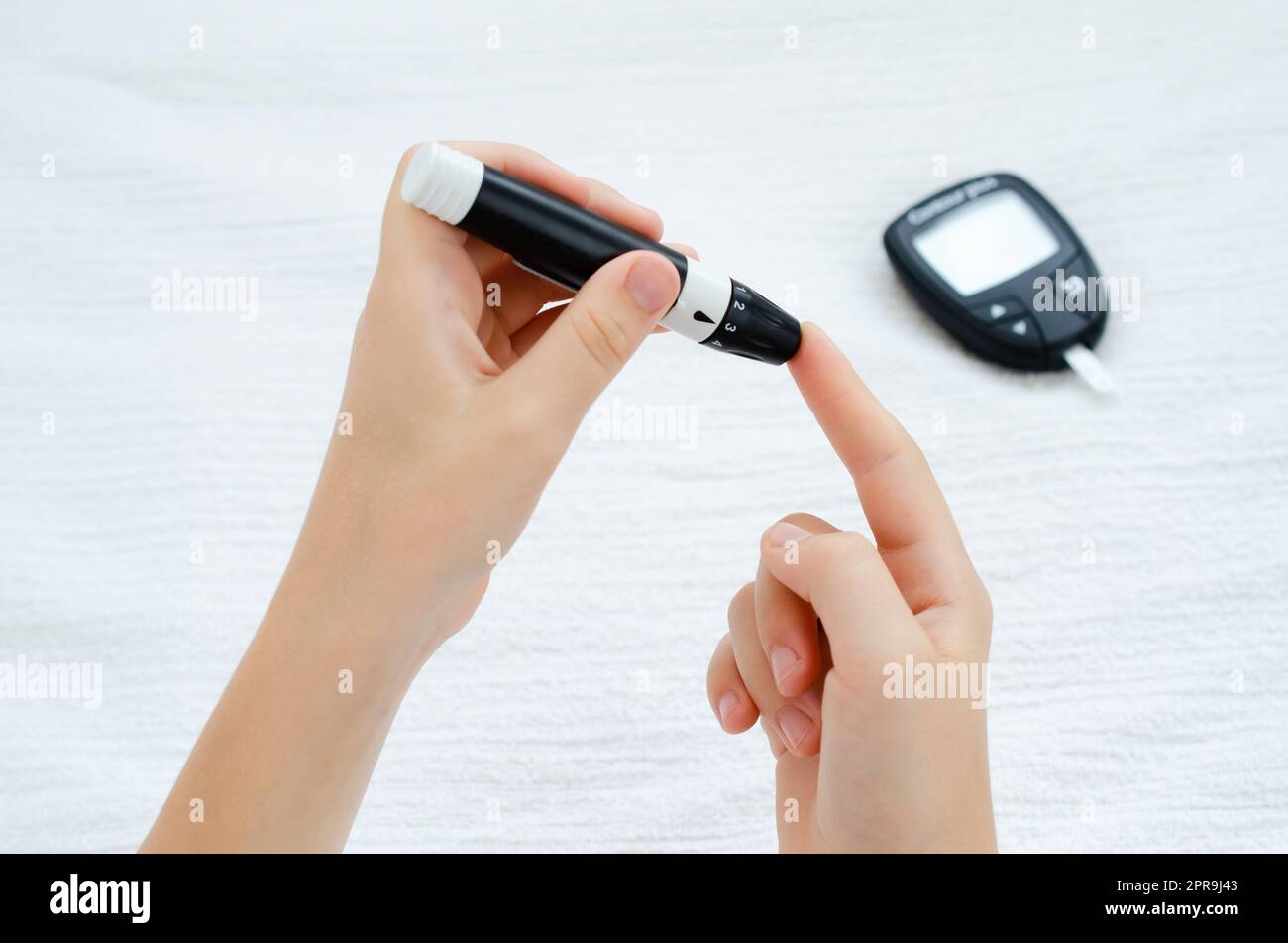 Diabetes checking blood sugar level. Child using lancelet and ...