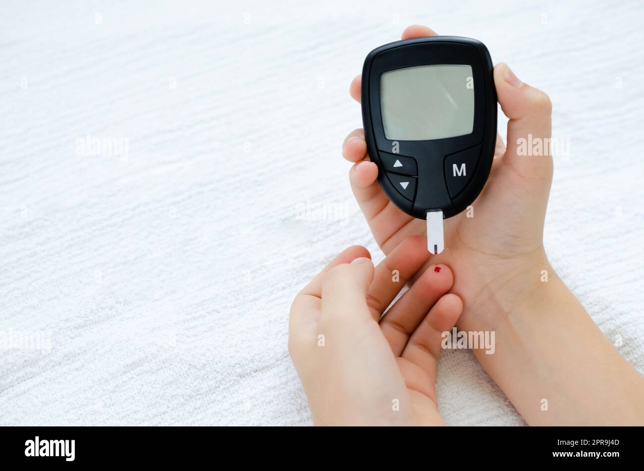 Diabetes test. Child hands checking blood sugar level by Glucose meter ...