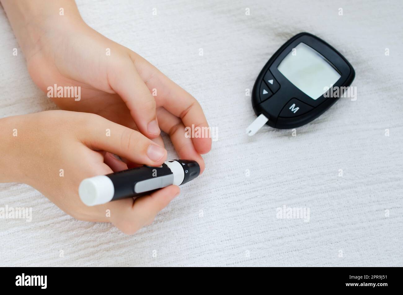 Diabetes checking blood sugar level. Child using lancelet and ...