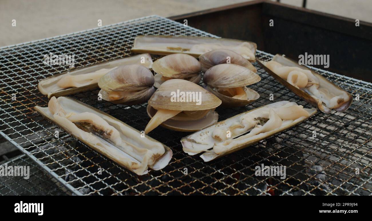 Fresh Short necked clam and Razor Clam on barbecue net Stock Photo - Alamy